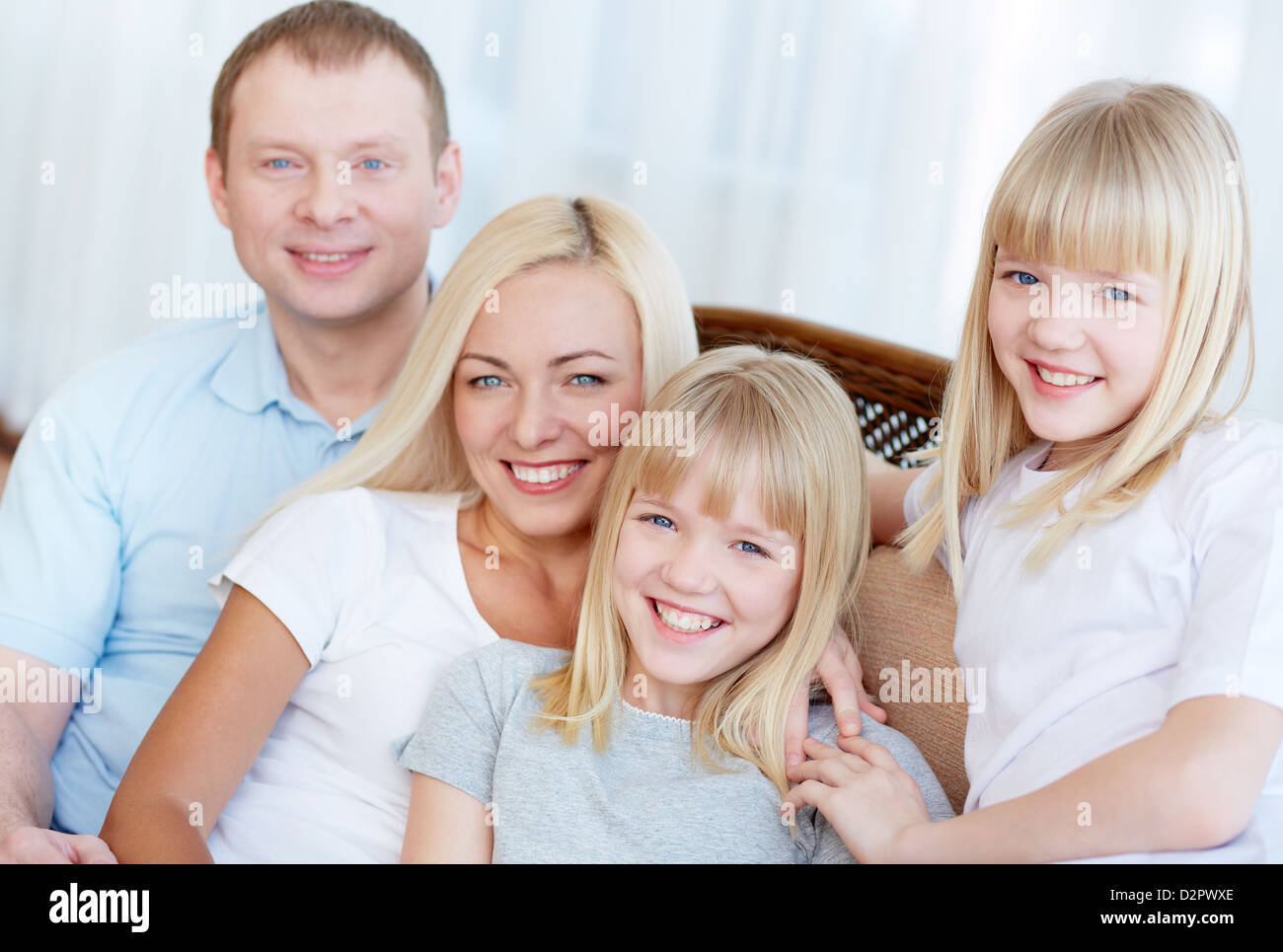 Portrait of happy family with two children smiling at camera Stock ...