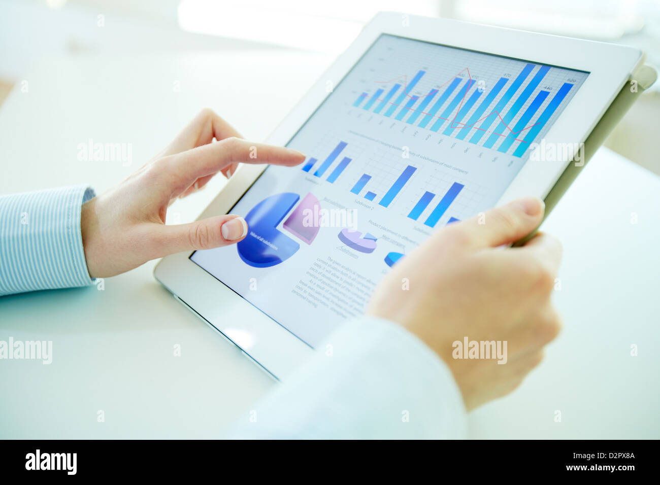 Business person analyzing financial statistics displayed on the tablet ... Business person analyzing financial statistics displayed on the tablet ...