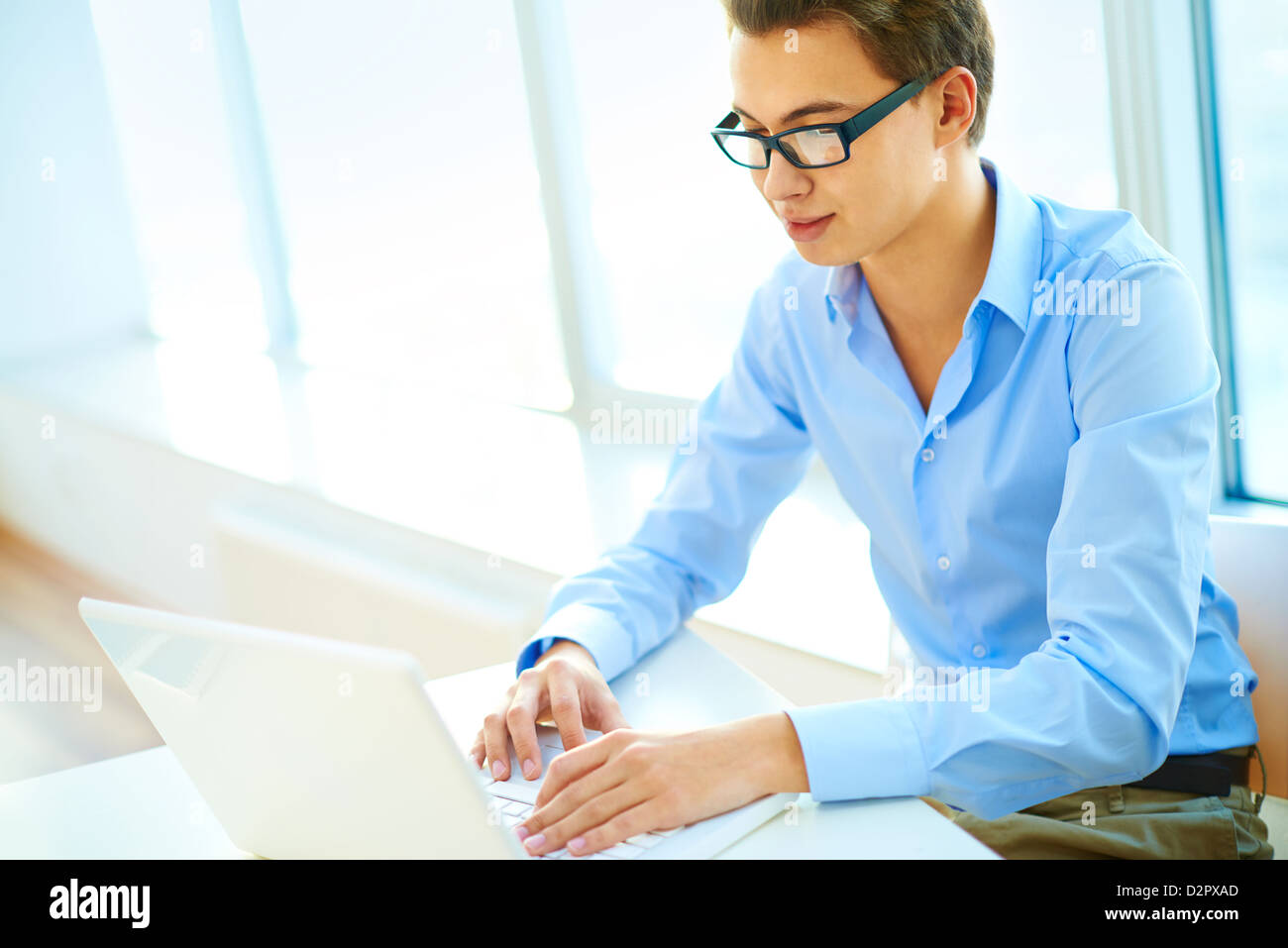 Image of a smart guy working on his laptop Stock Photo - Alamy