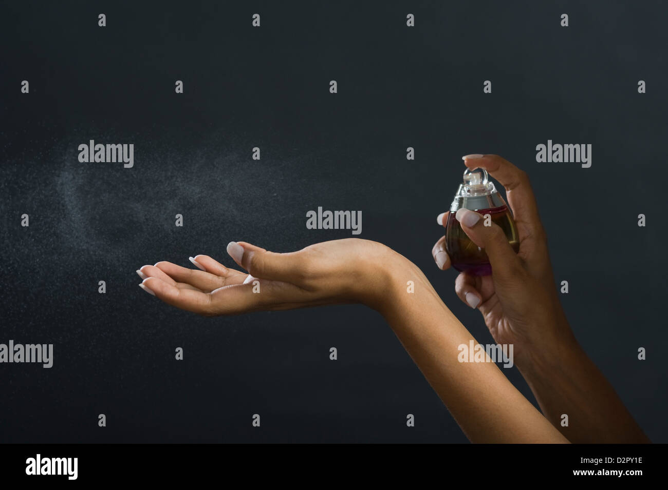 Woman spraying perfume on body hi-res stock photography and images - Alamy