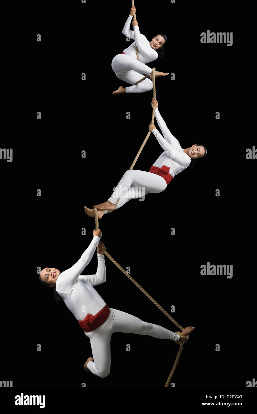 Male acrobats performing on a rope Stock Photo - Alamy