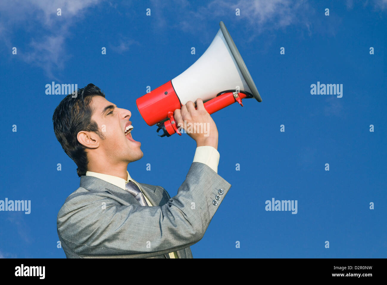 Businessman shouting into a megaphone Stock Photo - Alamy