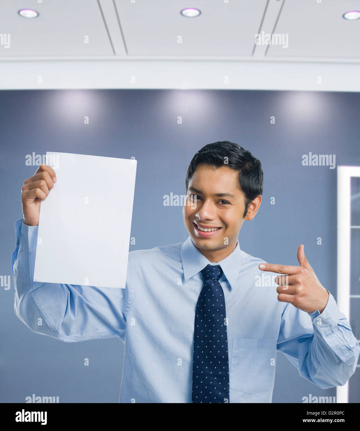 Businessman showing a blank sheet of paper Stock Photo - Alamy