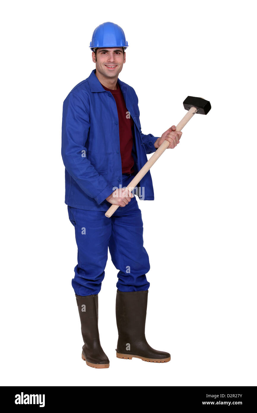 Laborer holding hammer Stock Photo - Alamy