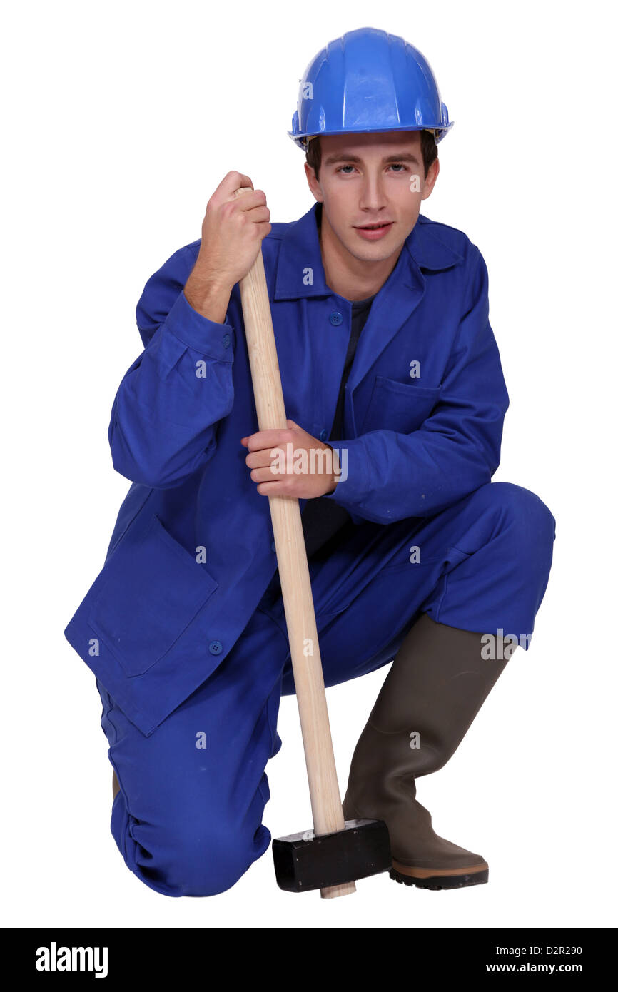 Labourer holding a mallet Stock Photo - Alamy
