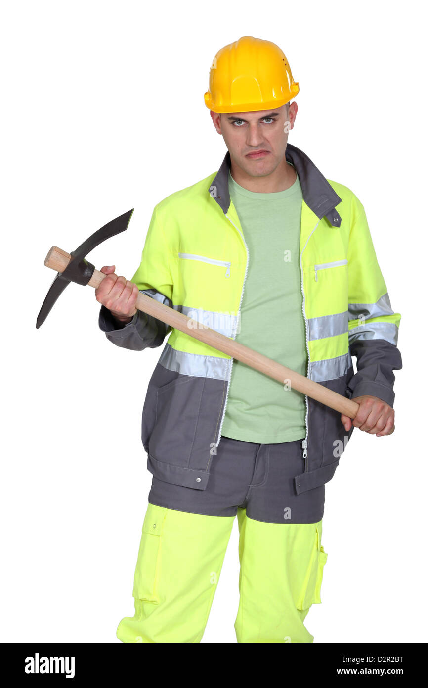 A man holding a pickaxe with a serial killer face Stock Photo - Alamy