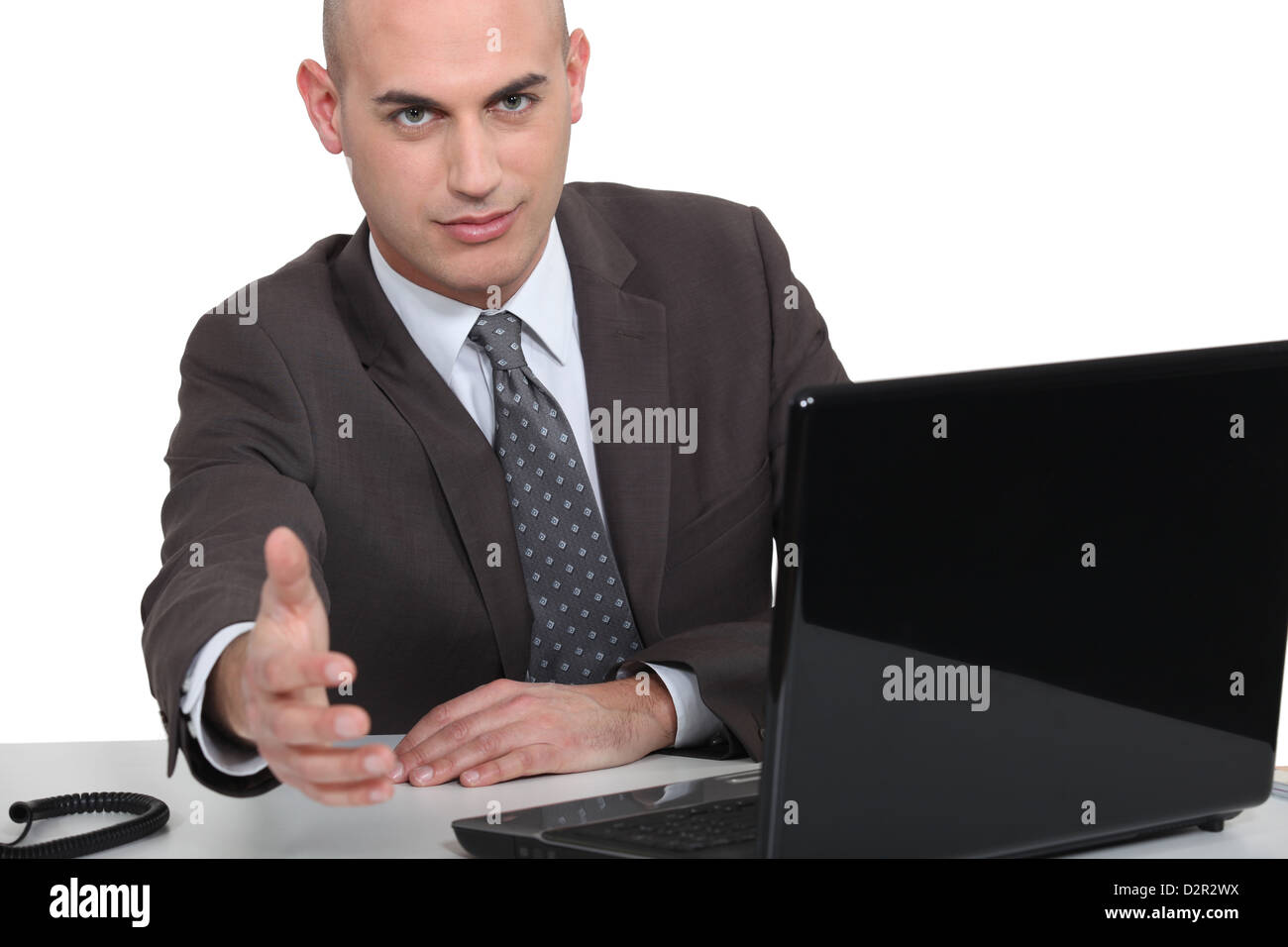 Businessman holding his hand out for a handshake Stock Photo - Alamy