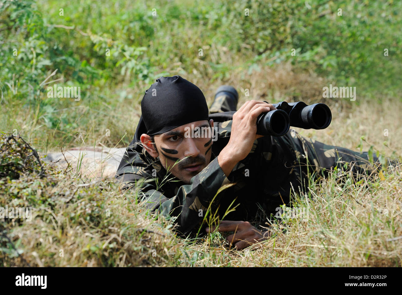 Soldier looking through binoculars in a forest Stock Photo - Alamy