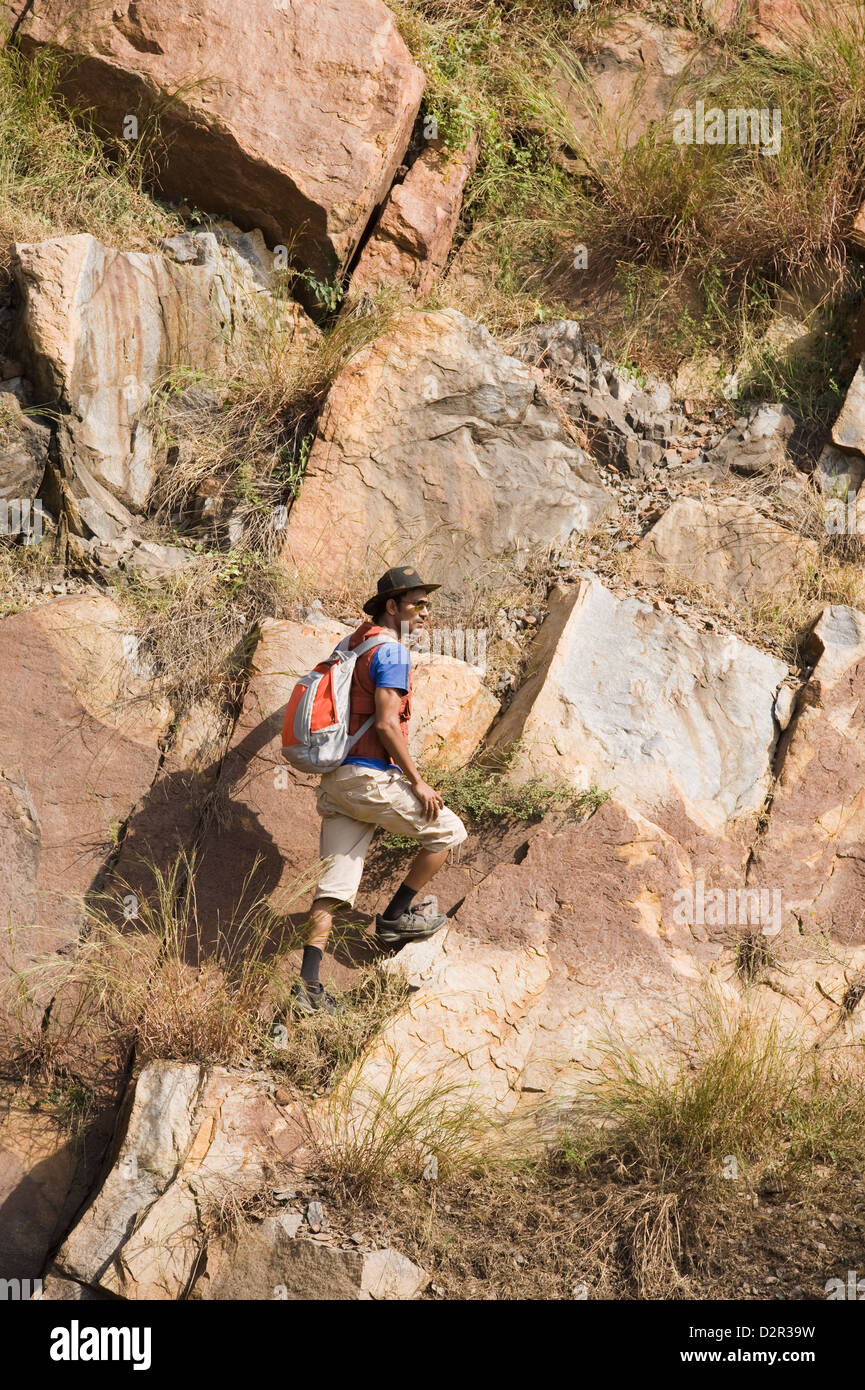 Hiker climbing on rocks Stock Photo - Alamy