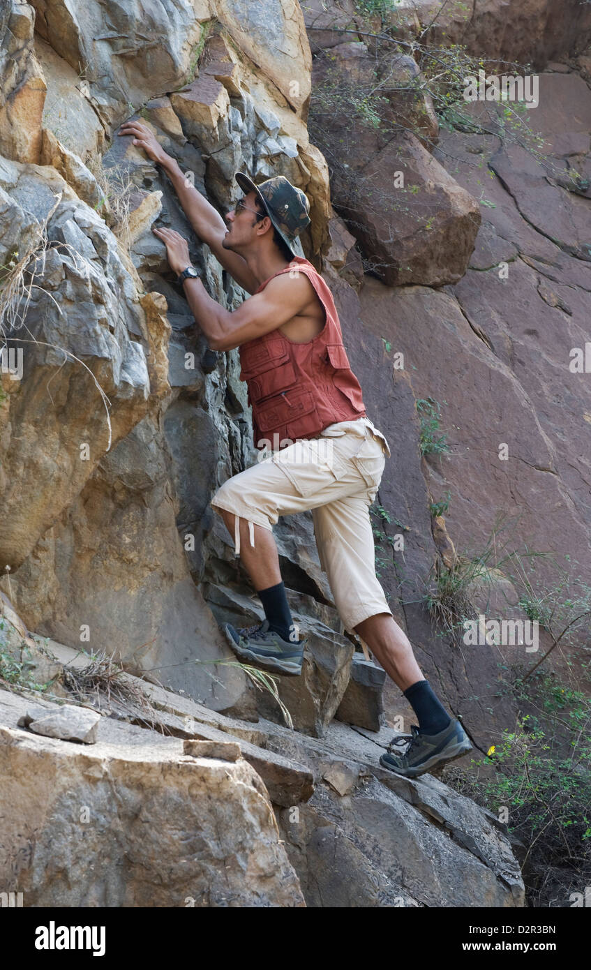 Man climbing on rocks Stock Photo - Alamy