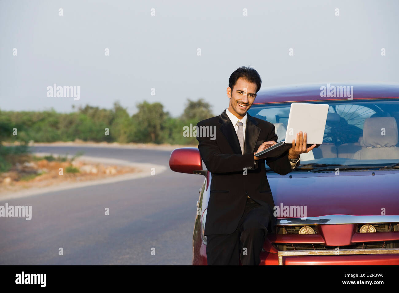 Using computer at side of road hi-res stock photography and images - Alamy