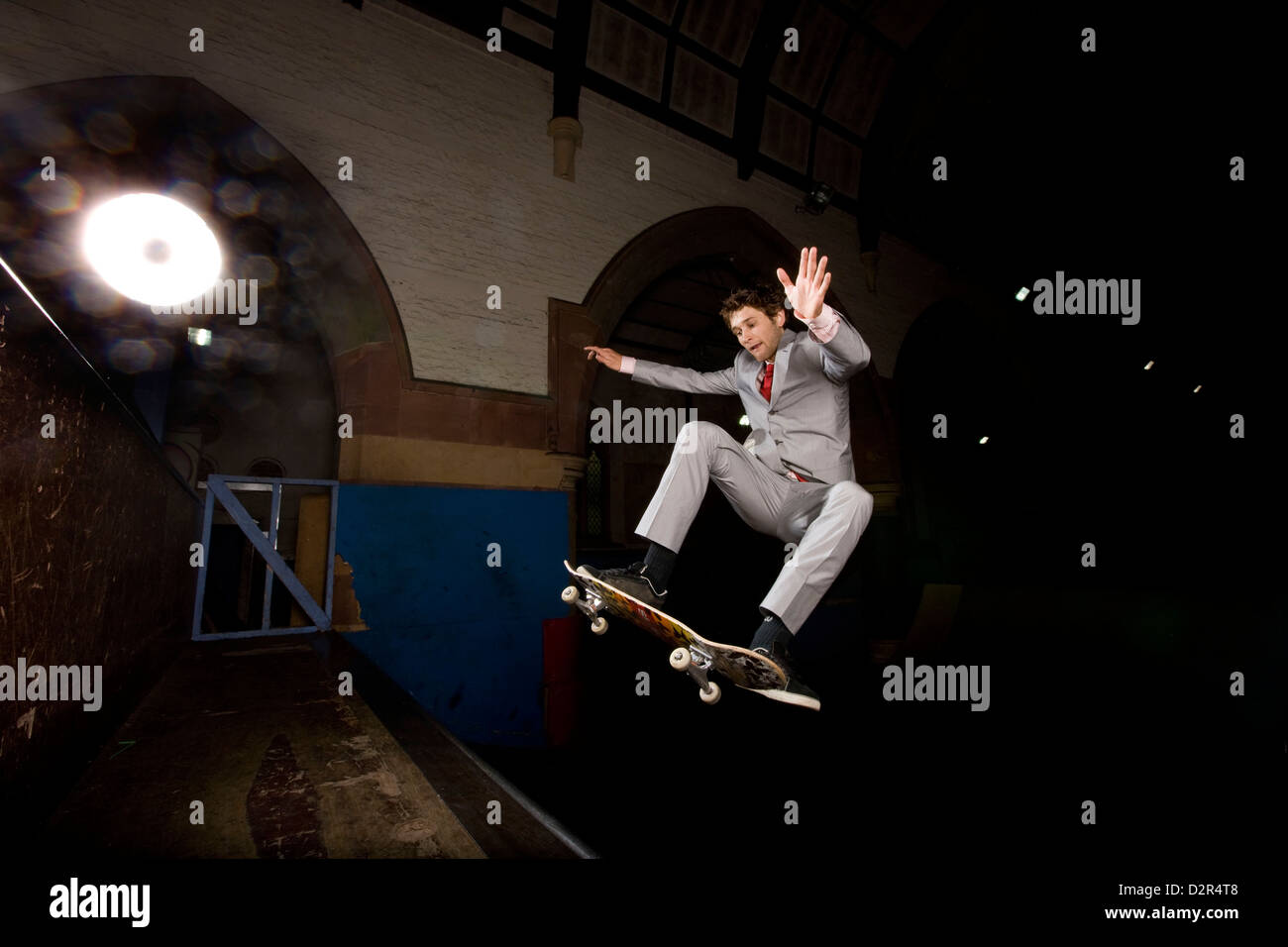 Skateboarder in suit falling from ramp in church Stock Photo - Alamy