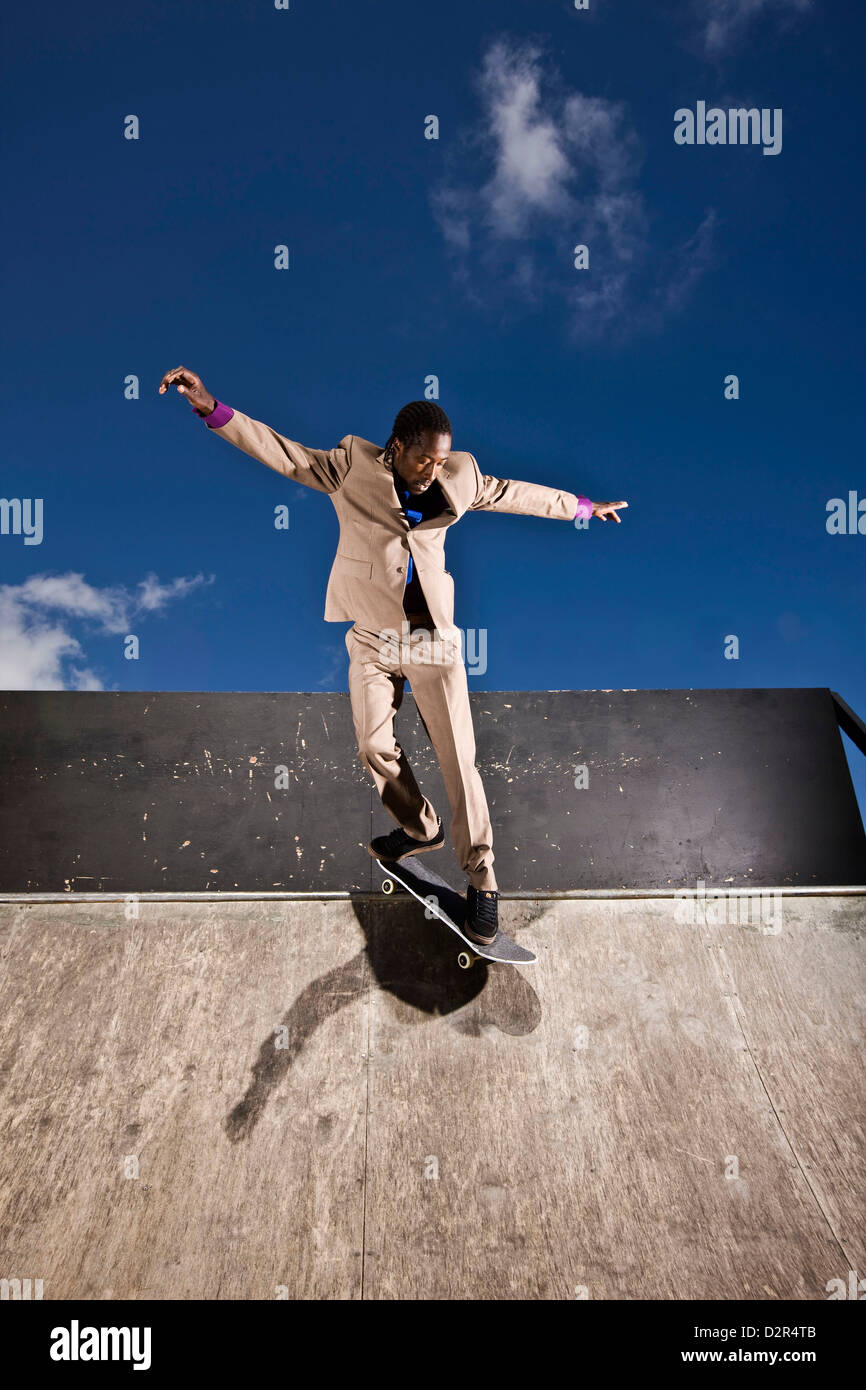 Skateboarding balance in full suit, London Stock Photo - Alamy