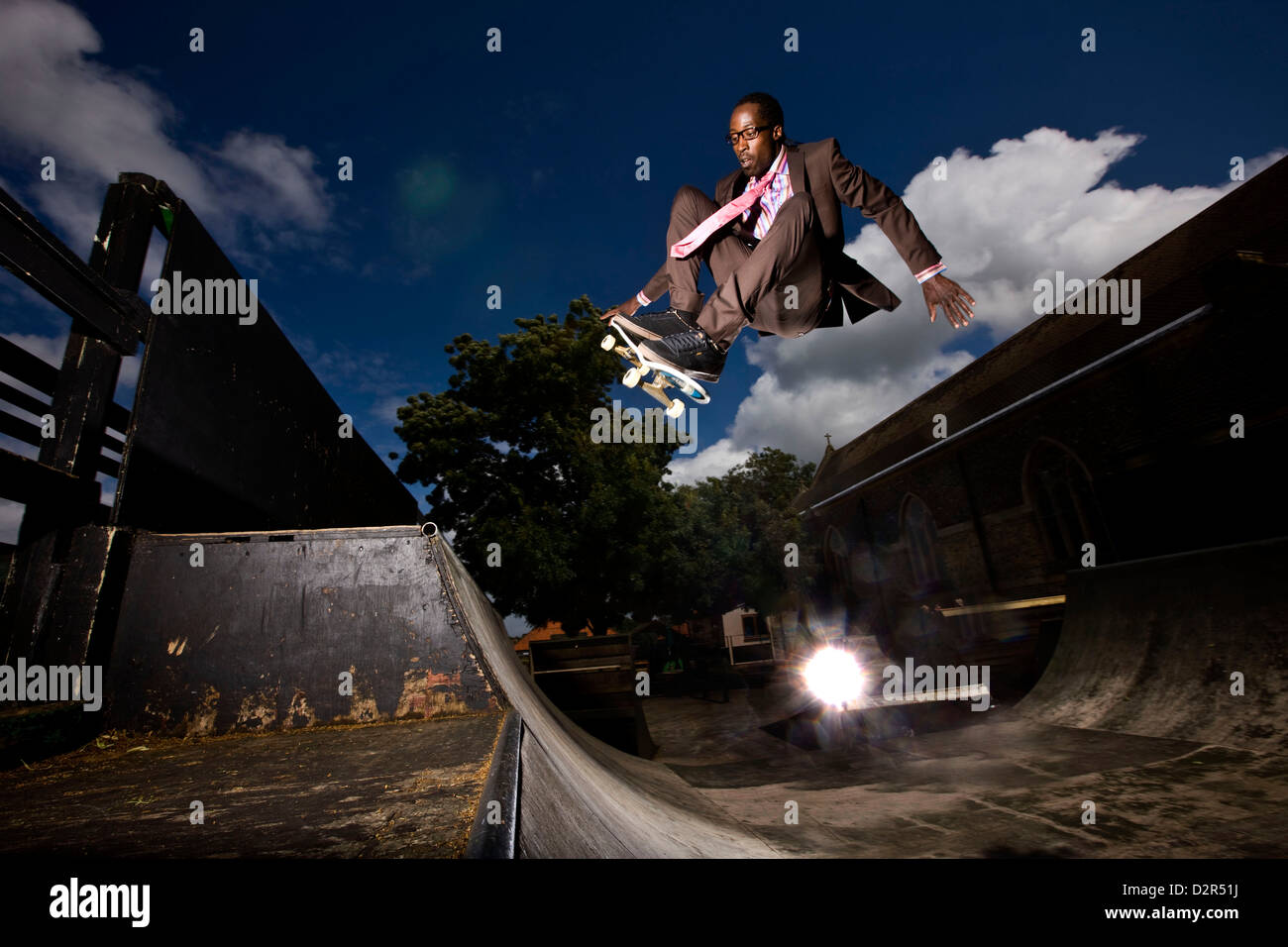 Skateboarder in suit on ramp, mid air action stunt Stock Photo - Alamy