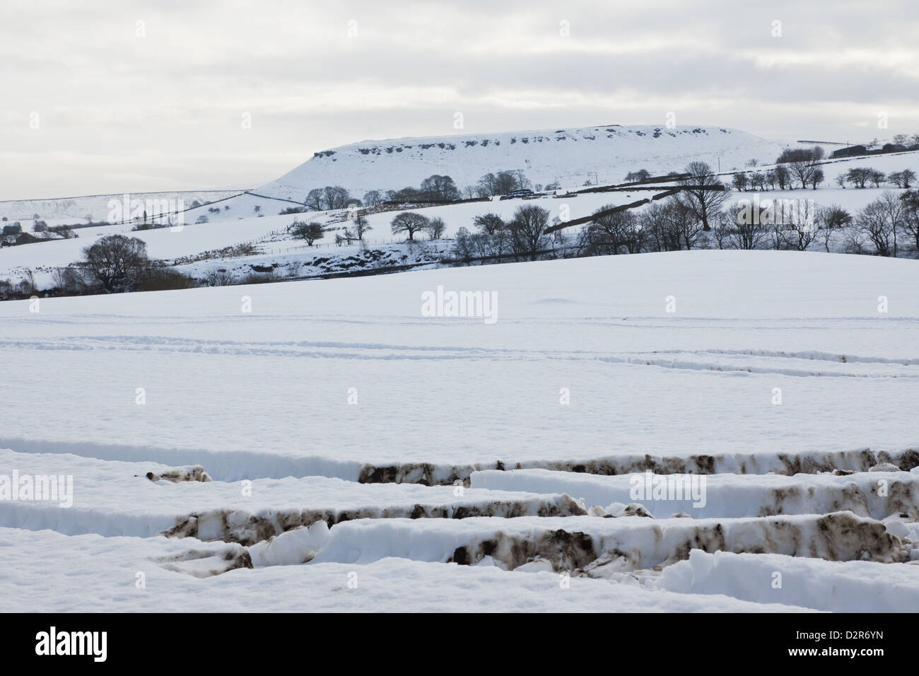 Snow covered landscape with hill in background Stock Photo - Alamy