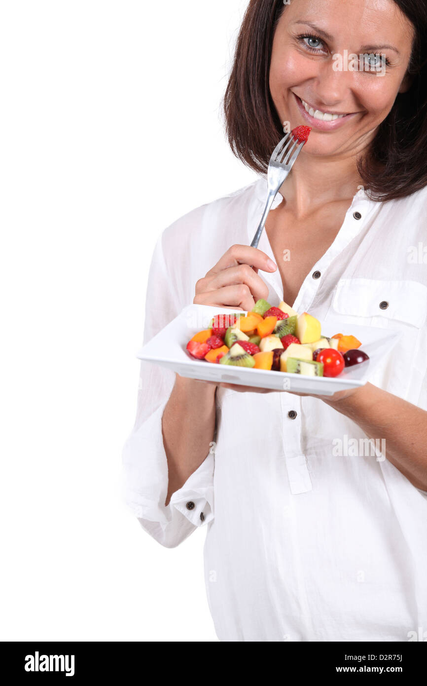 Woman holding plate of fruit salad Stock Photo - Alamy