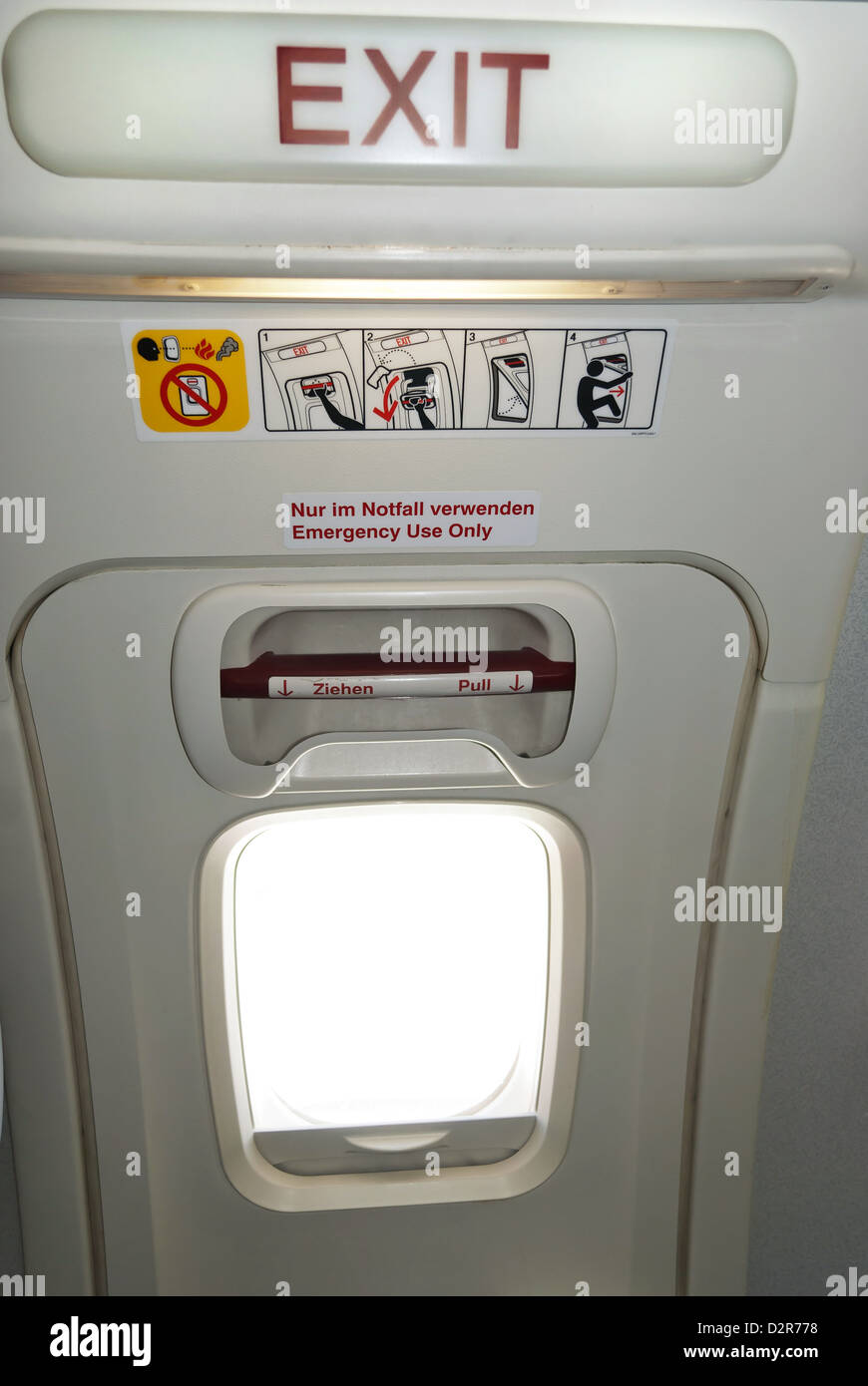 Emergency exit in the aircraft, text in English and German Stock Photo ...