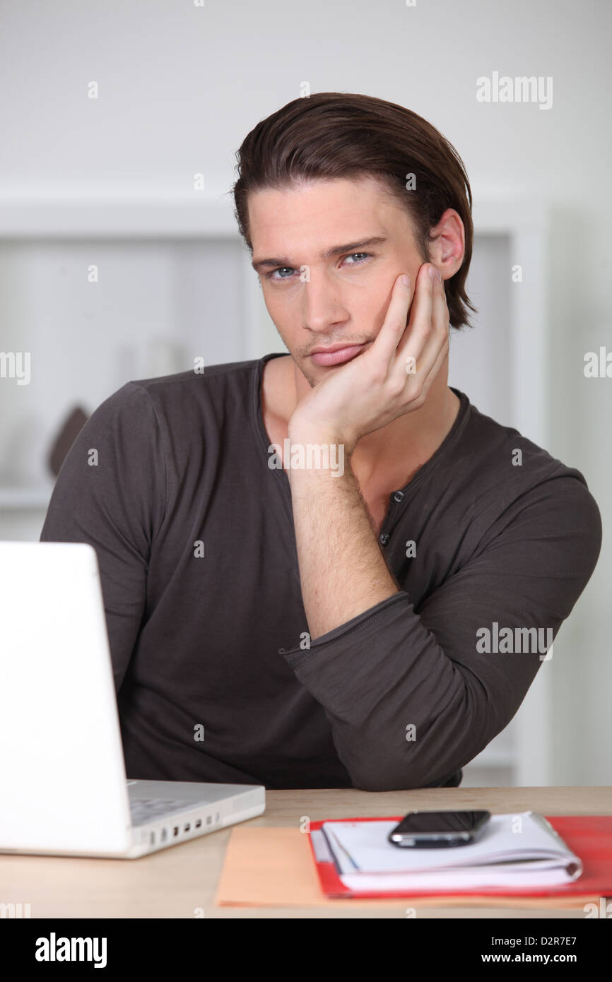 Man bored working at home Stock Photo - Alamy