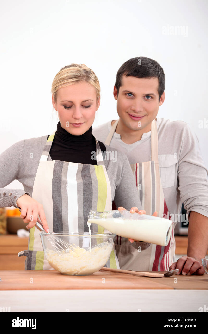 Couple baking together in kitchen Stock Photo - Alamy