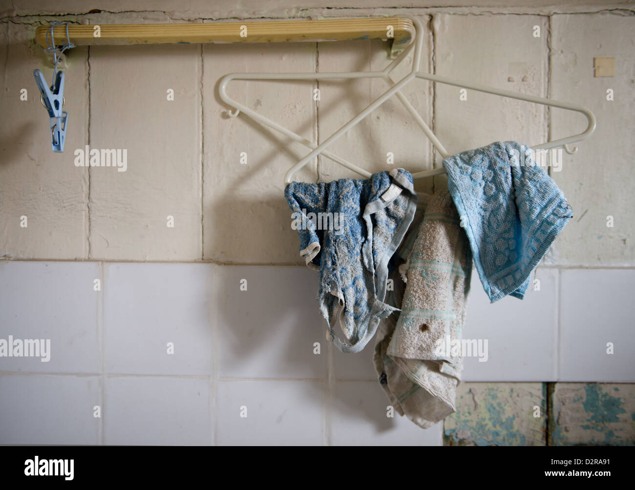 old blue and white rags drying on a hanger against a rustic old ...