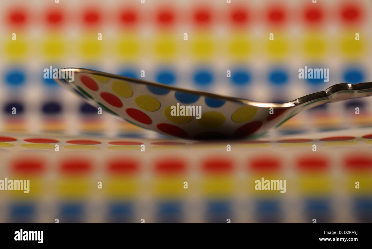Spoon with coloured dots Stock Photo - Alamy