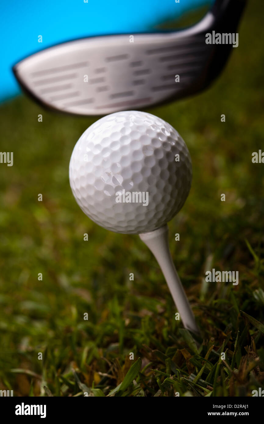 Golf ball about to be hit with club from tee Stock Photo - Alamy