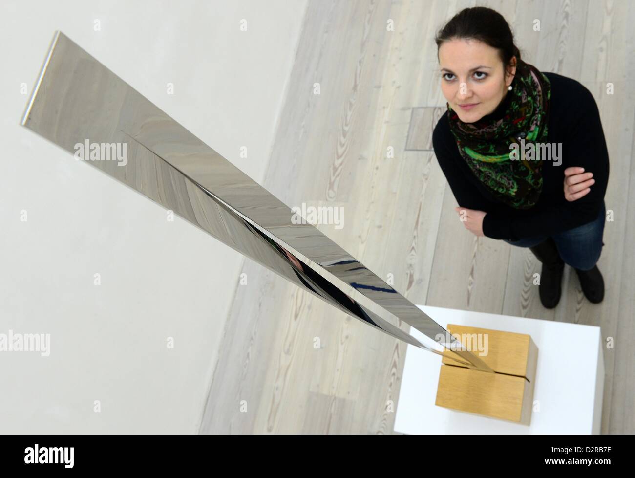 A young woman looks at the sculpture "Never Ending Space in Form of a ...