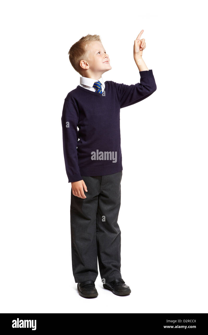 8 year old school boy pointing up on white background Stock Photo - Alamy