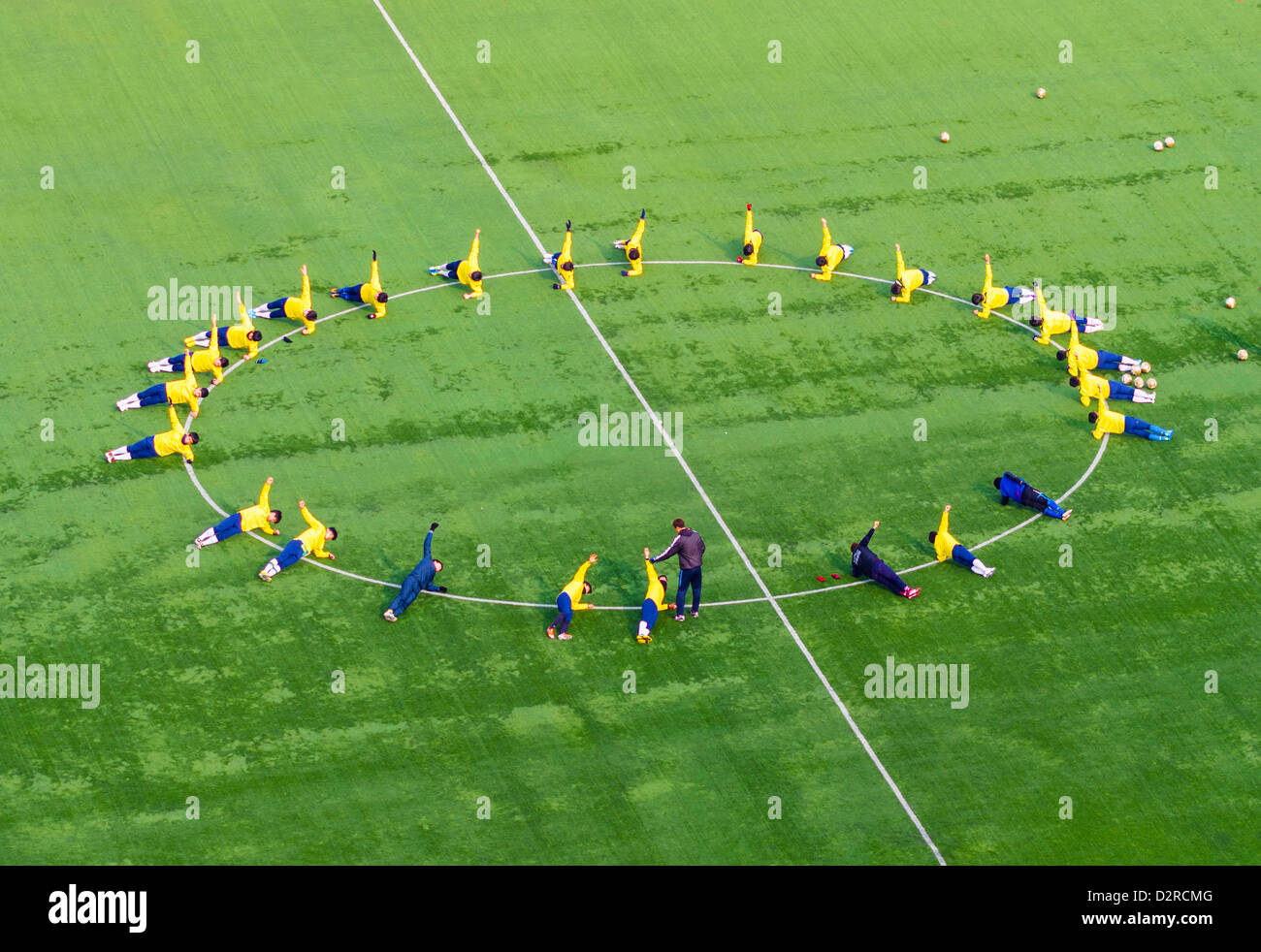 Team of soccer players practising at the center circle of the soccer ...