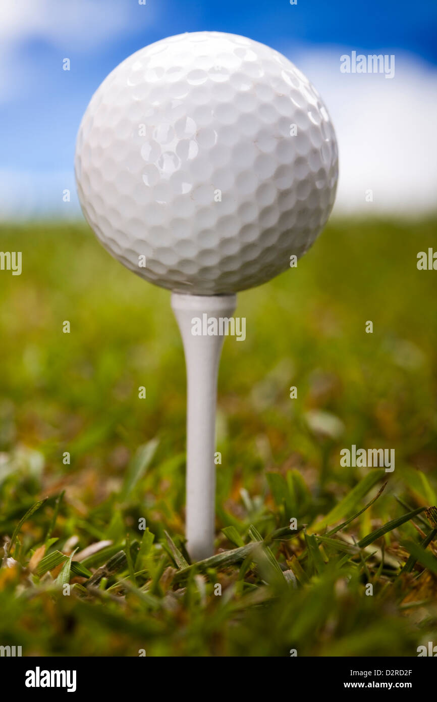 Playing golf, ball on tee Stock Photo - Alamy