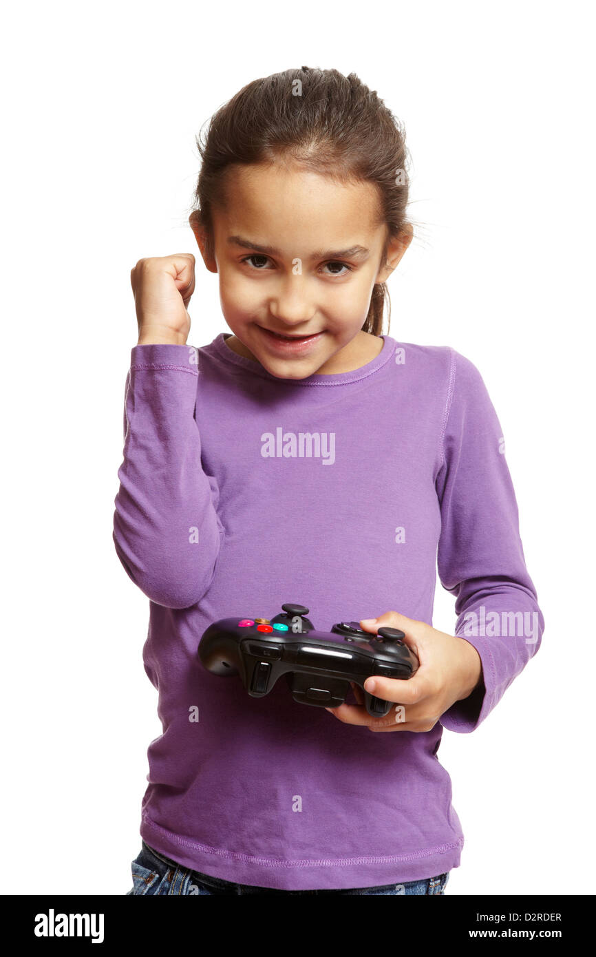 8 year old girl playing games console holding controller on white ...