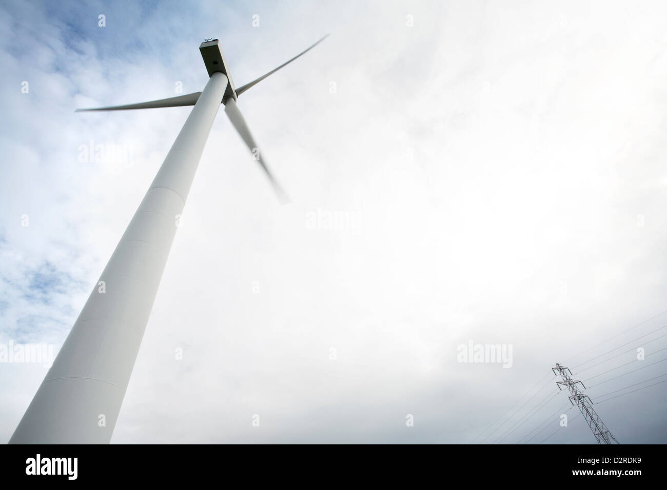 Wind Turbine with electricity pylon Stock Photo - Alamy
