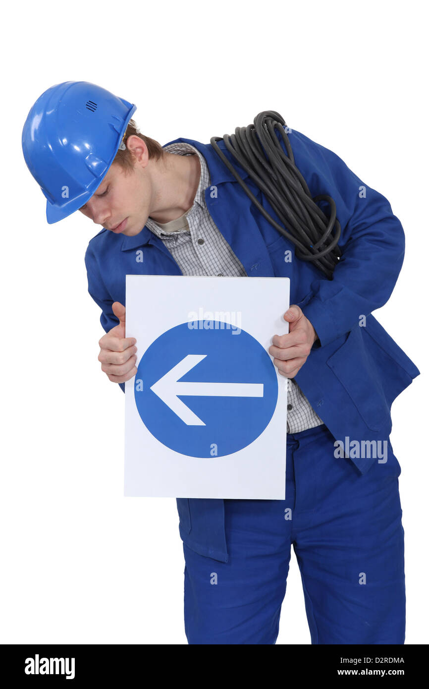 A road worker holding an arrow sign Stock Photo - Alamy