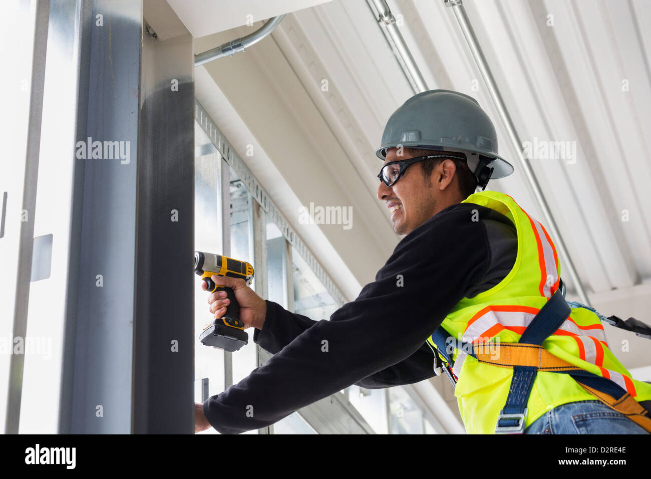 Hispanic man working at construction site Stock Photo - Alamy