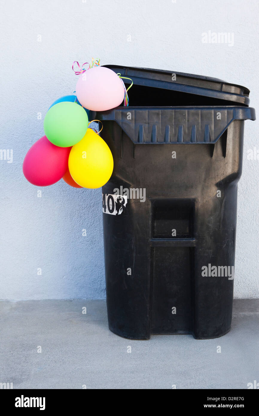 Bunch of balloons in garbage can Stock Photo - Alamy