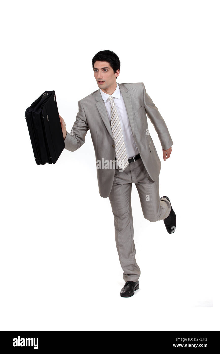 Businessman with briefcase running Stock Photo - Alamy