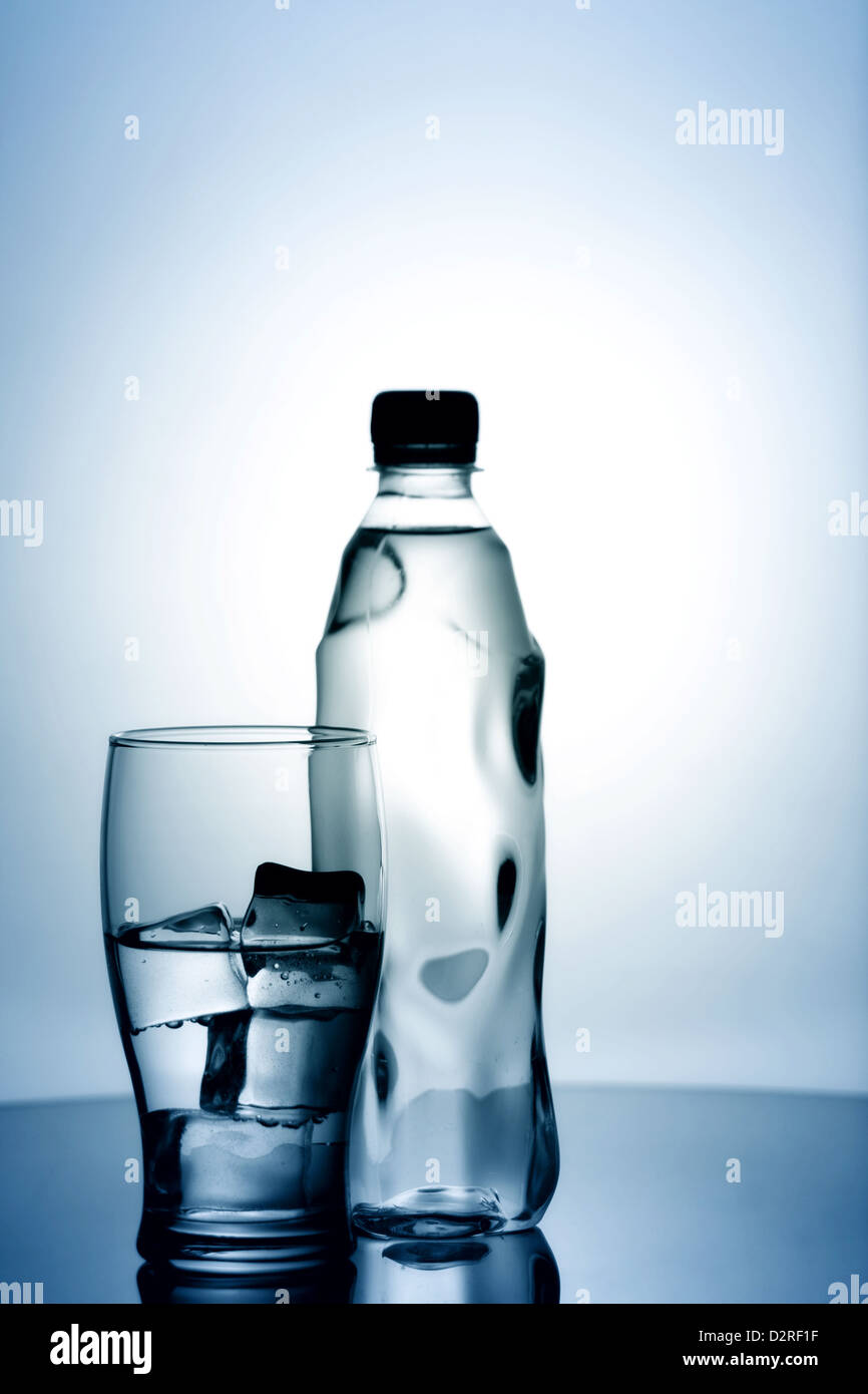 glass of cold mineral water with ice and plastic bottle Stock Photo - Alamy