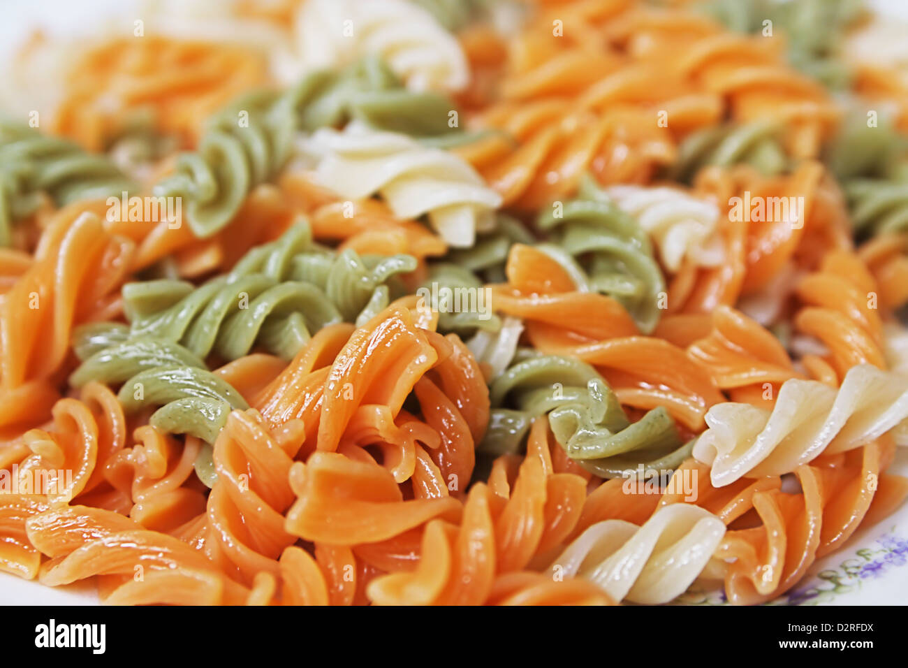 Plateful of cooked colored pasta as background Stock Photo - Alamy