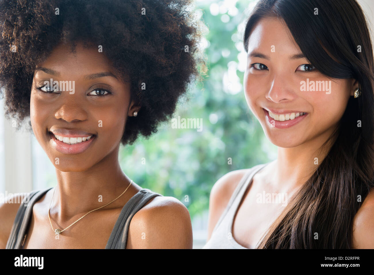 Smiling women standing together Stock Photo - Alamy