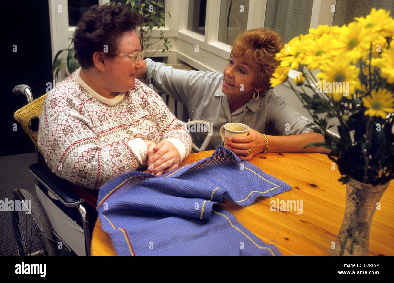 Disabled woman with helper in day centreoman with Stock Photo - Alamy
