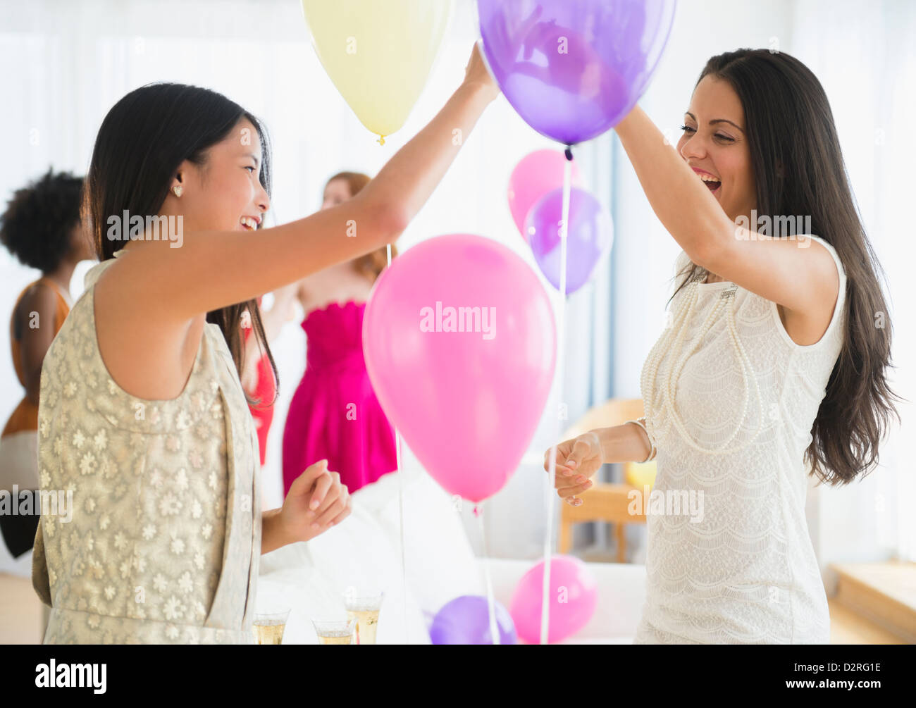Women playing with balloons at party Stock Photo - Alamy