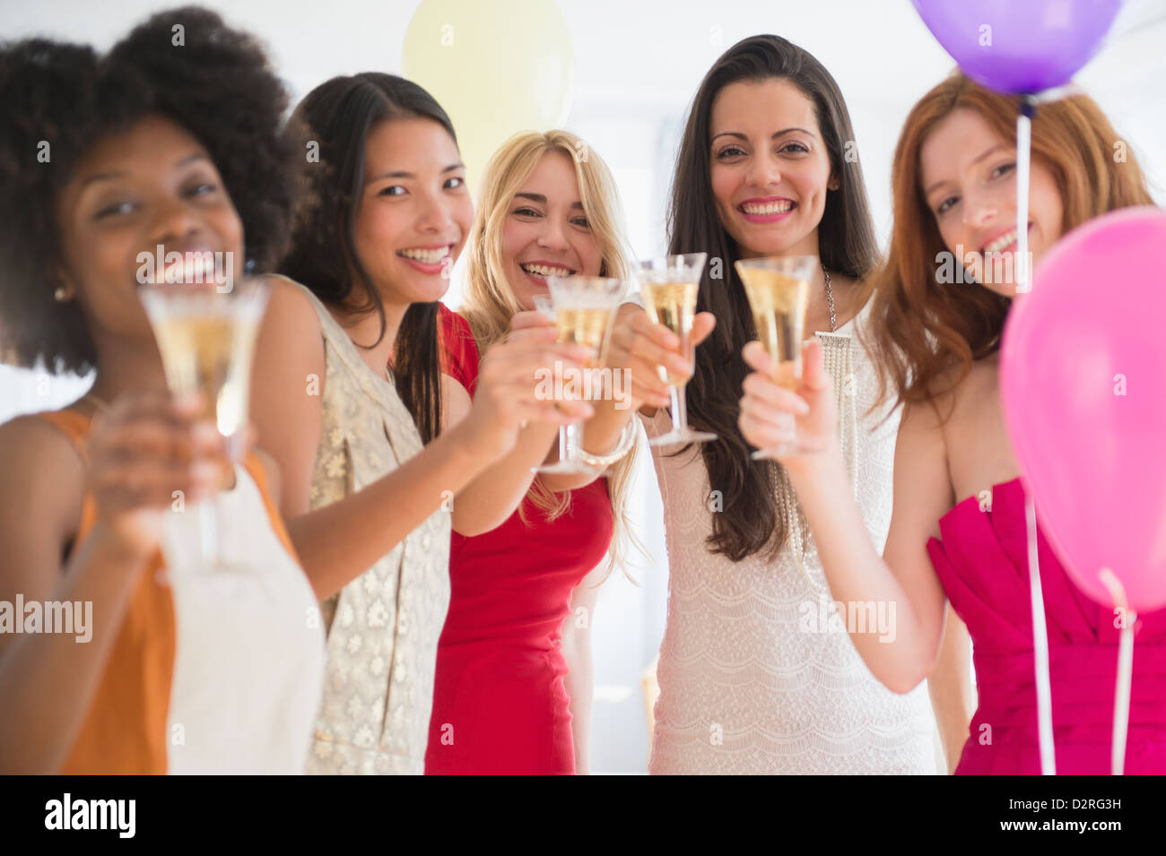 Women toasting each other with champagne at party Stock Photo - Alamy