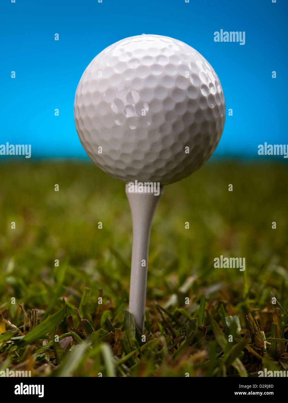 Playing golf, ball on tee Stock Photo - Alamy