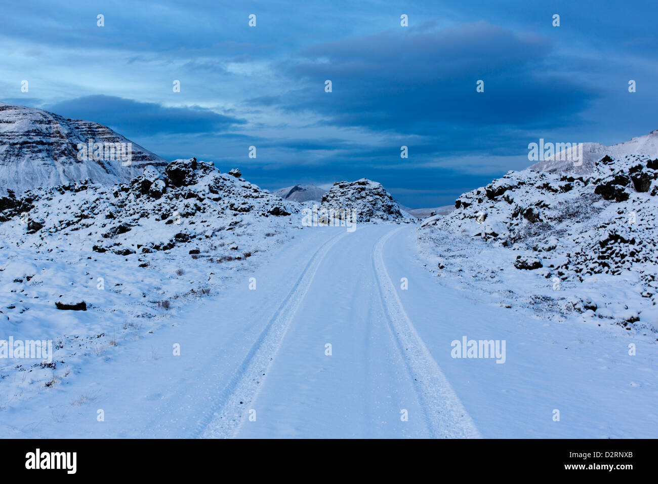 Tire tracks and snow covered lava and road in Berserkjahraun ...