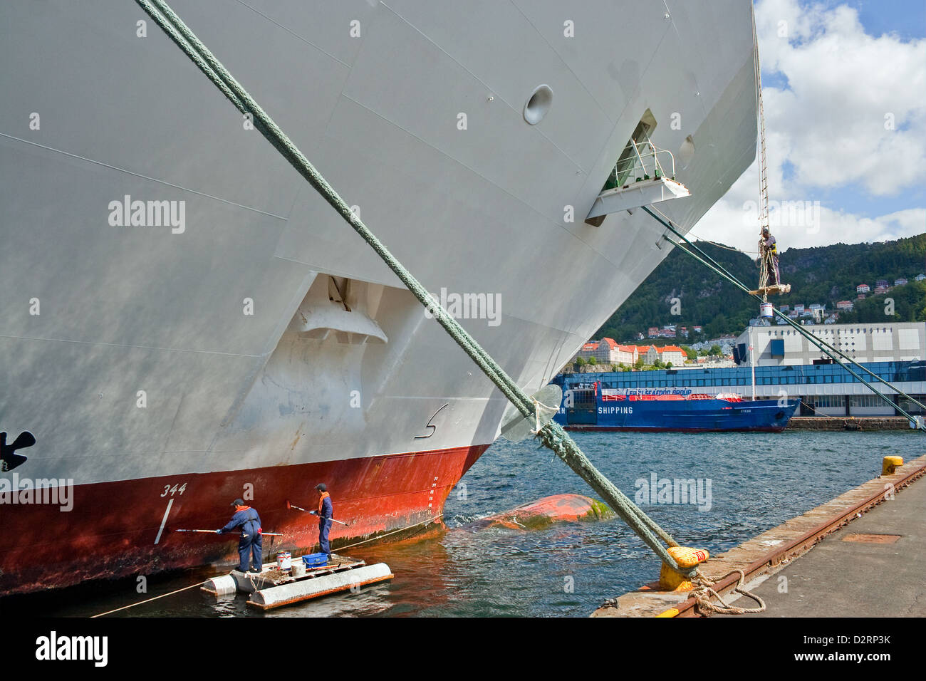 Crewmen touching up the paintwork of the P&O cruise ship Aurora, moored ...