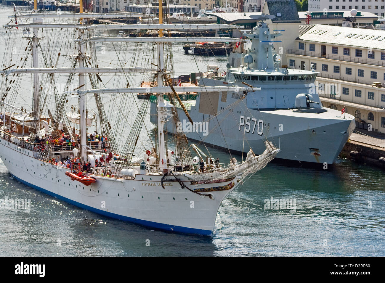 The tall ship Statsraad Lemkuhl passes the visiting Danish arctic ...