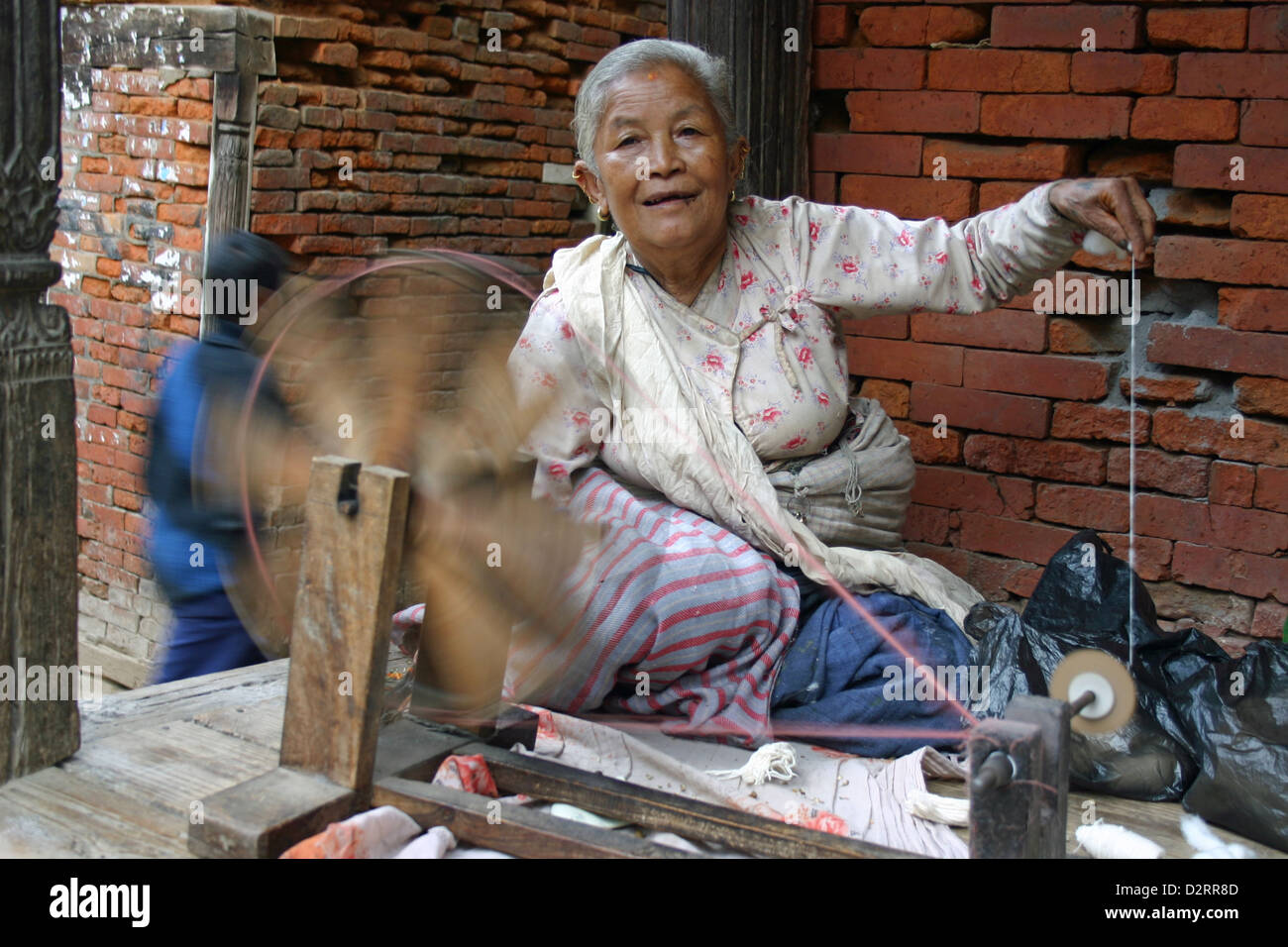 Old lady spinning silk in hi-res stock photography and images - Alamy
