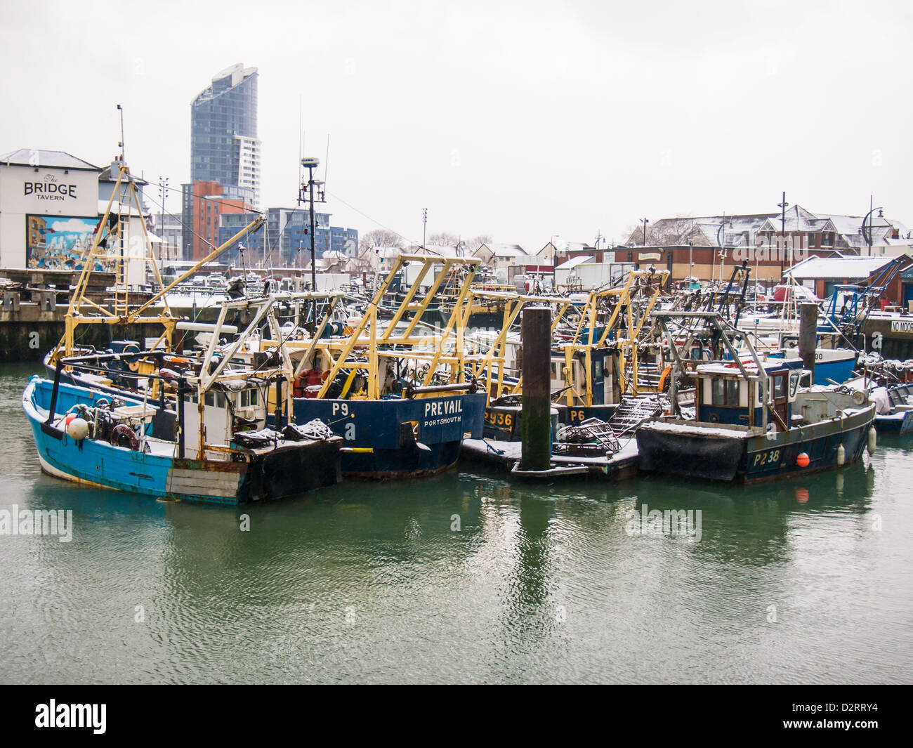 Fishing boats in Camber Docks, Portsmouth covered in a layer of snow ...