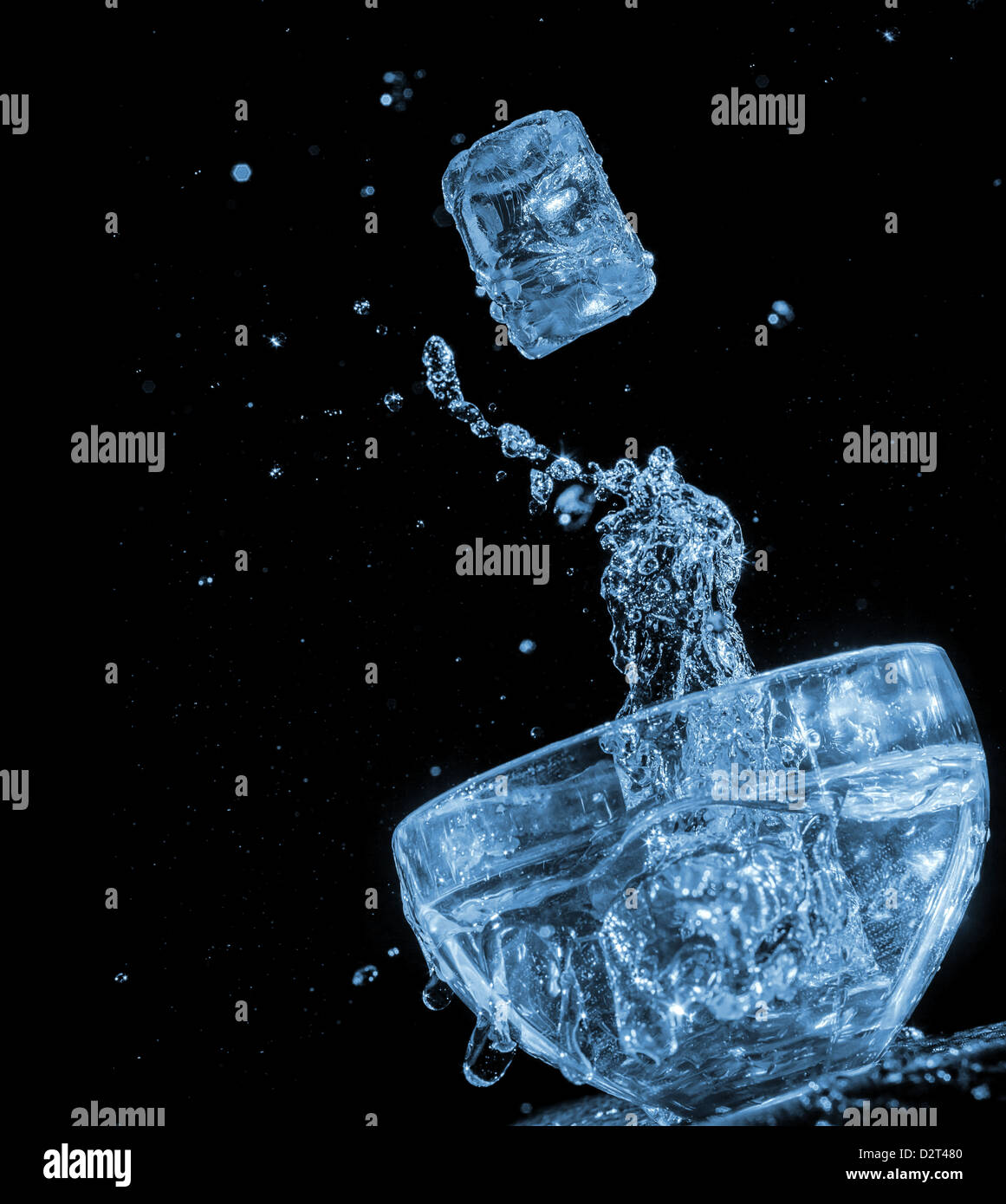 Ice cube falling into water in glass, energy drink Stock Photo - Alamy