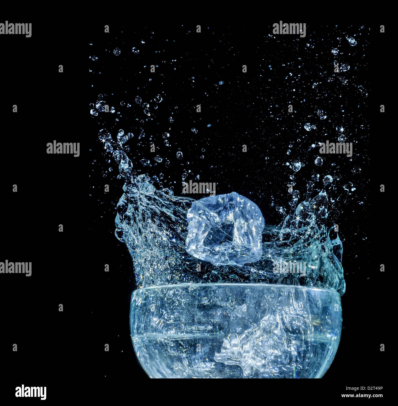 Ice cube falling into water in glass, energy drink Stock Photo - Alamy